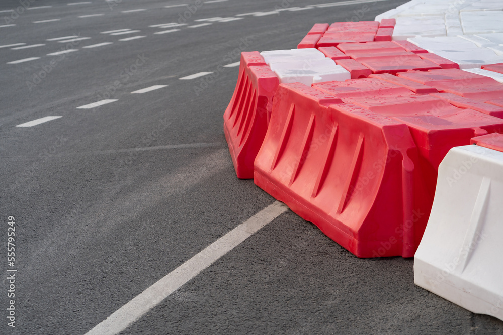 Temporary road barriers installed on asphalt with intermittent markings ...