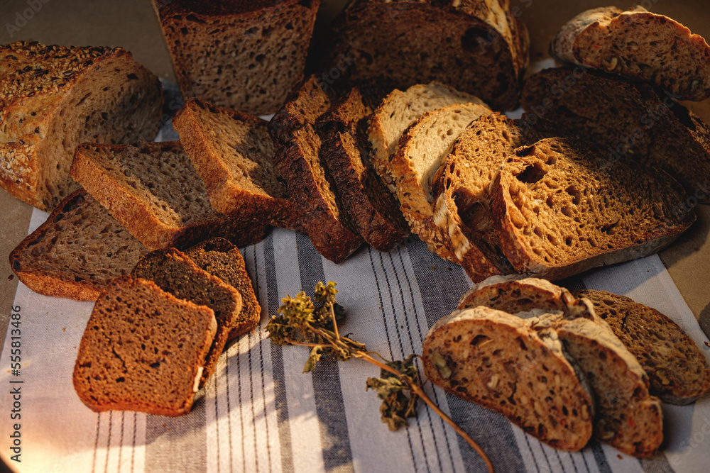 Bread, traditional sourdough bread, cut into slices on a rustic ...