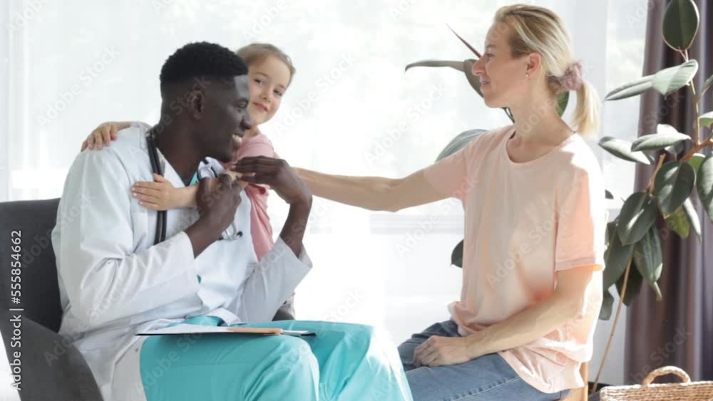 a happy girl hugs a doctor after an appointment in the office. Stock ...