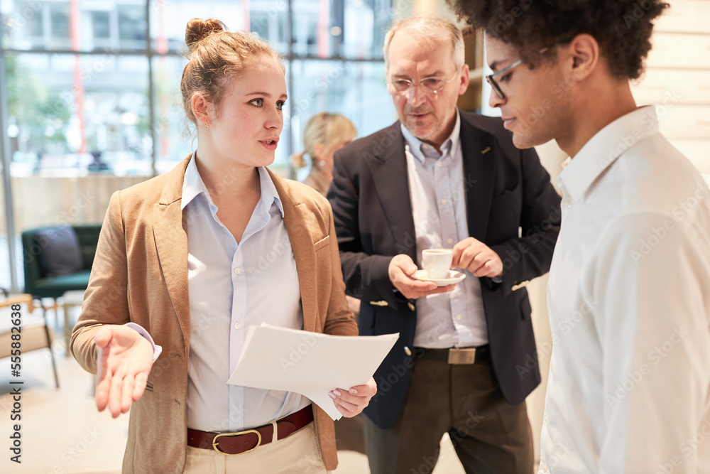 Young business woman discussing a problem with colleagues Stock Photo ...