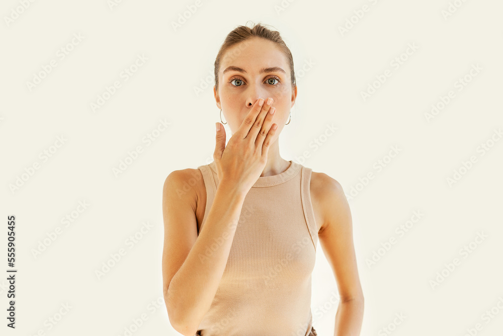 Pretty caucasian young woman accidentally told secret, covering mouth ...