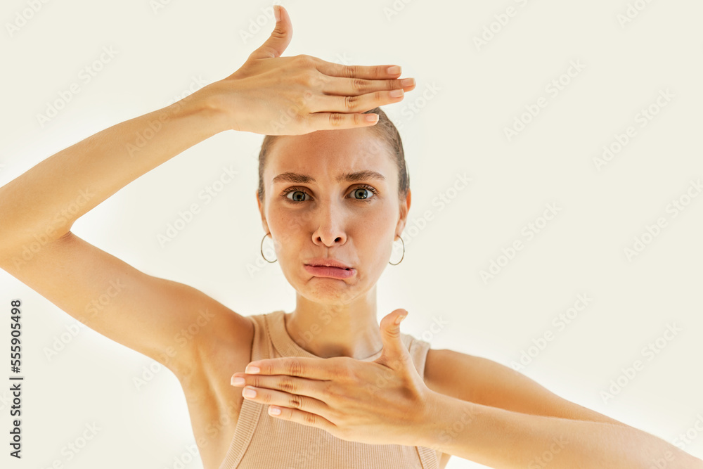 Embarrassed offended woman making frame with hands, posing with curved ...