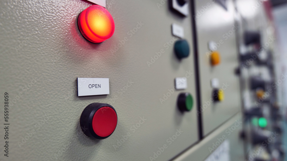 Electric control cabinet with control buttons and lamps indicating the ...