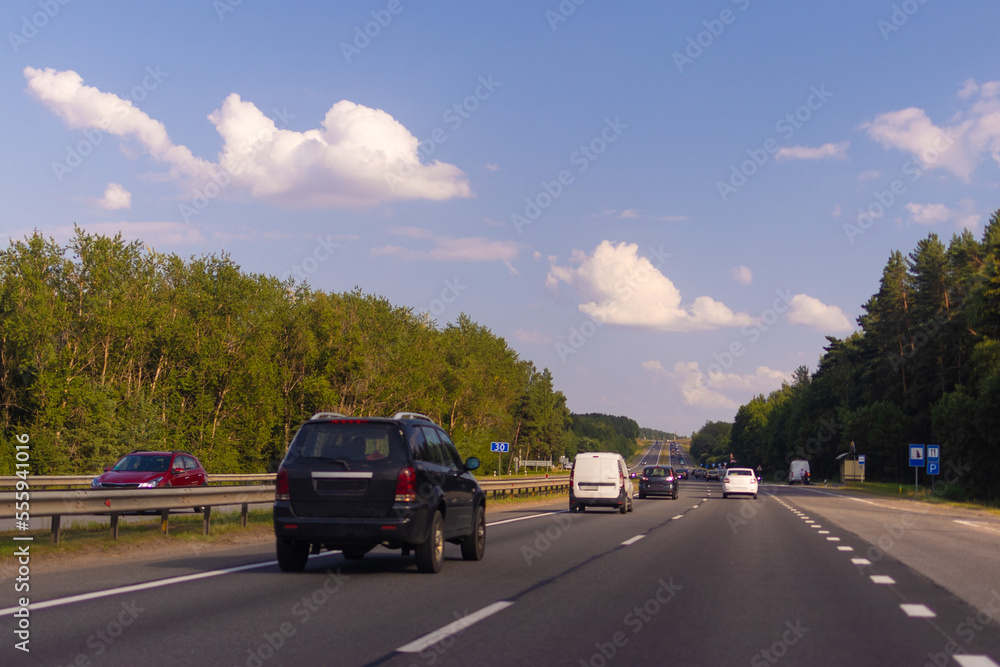 Highway wide road in the city, transport and blue sky with clouds on a ...