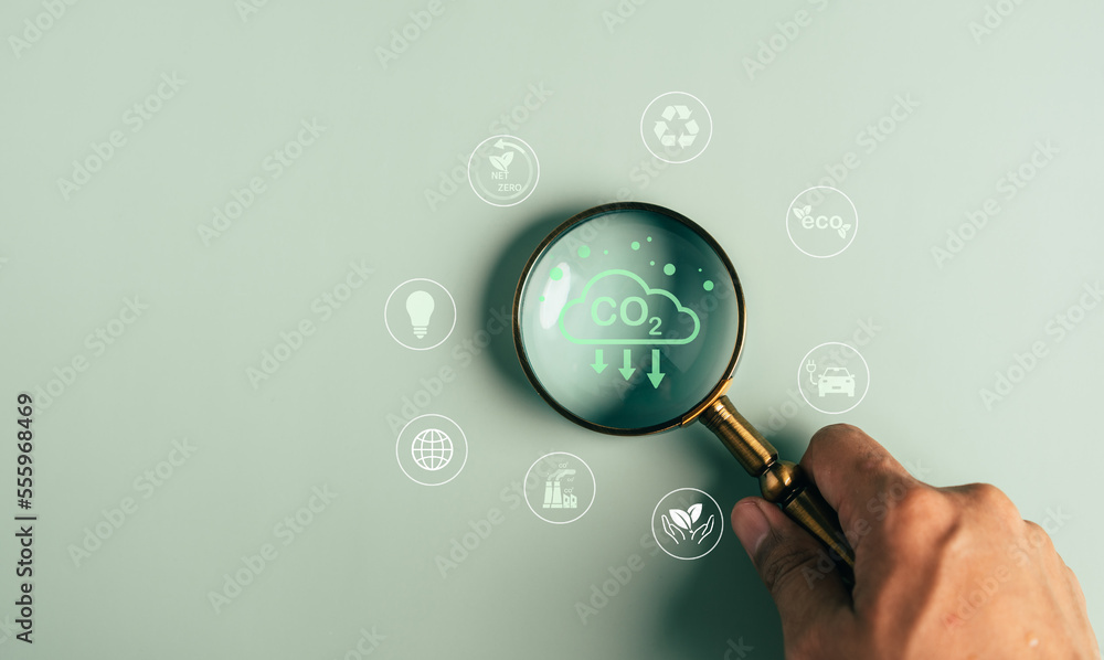Magnifier focus to CO2 reduction icon on global earth decrease CO2 or carbon dioxide emission ...