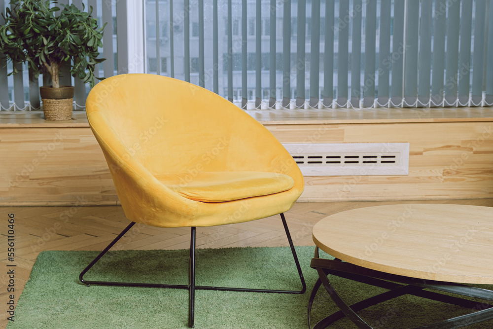 Yellow fabric round armchair in an office interior. Armchair without ...