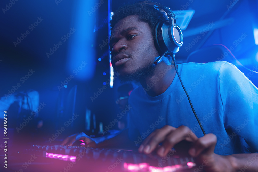 Portrait gamer American African man with headphones neon background ...