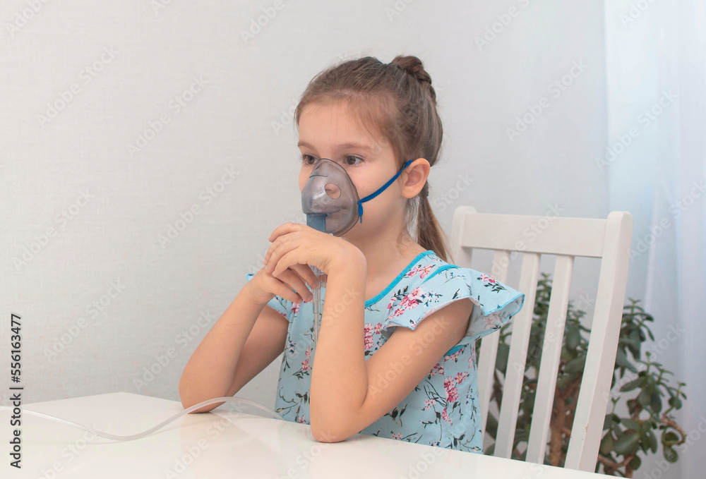 girl is holding an inhaler and breathing. He was filmed for articles ...