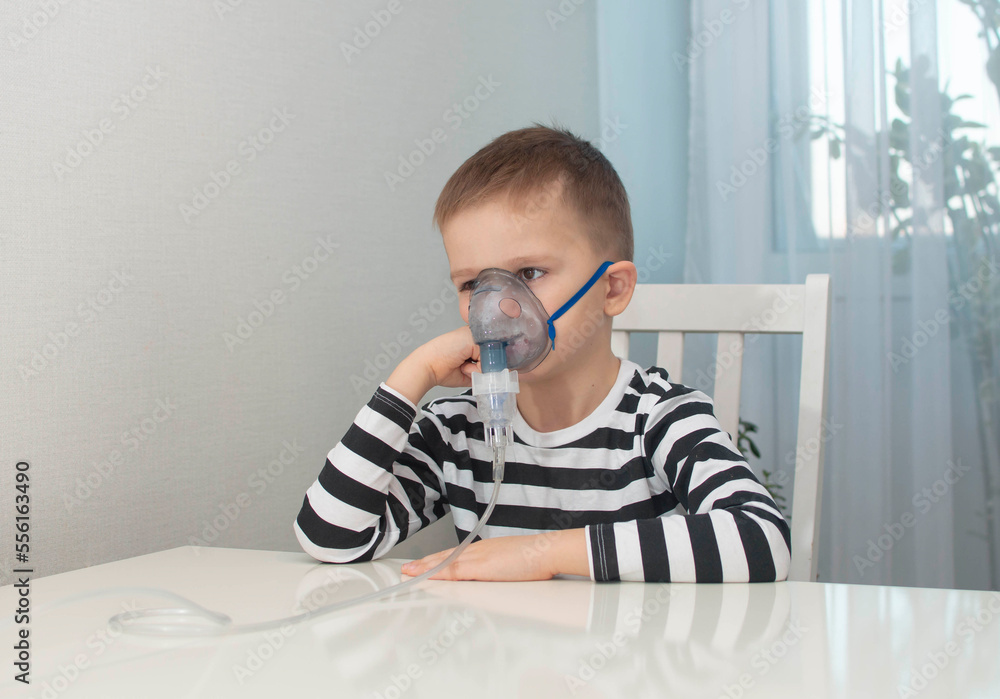 Boy is holding an inhaler and breathing. He was filmed for articles ...