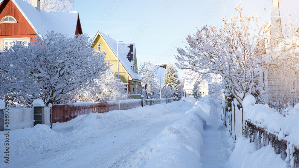 Winter fairy-tale landscape on the street with houses with a triangular ...