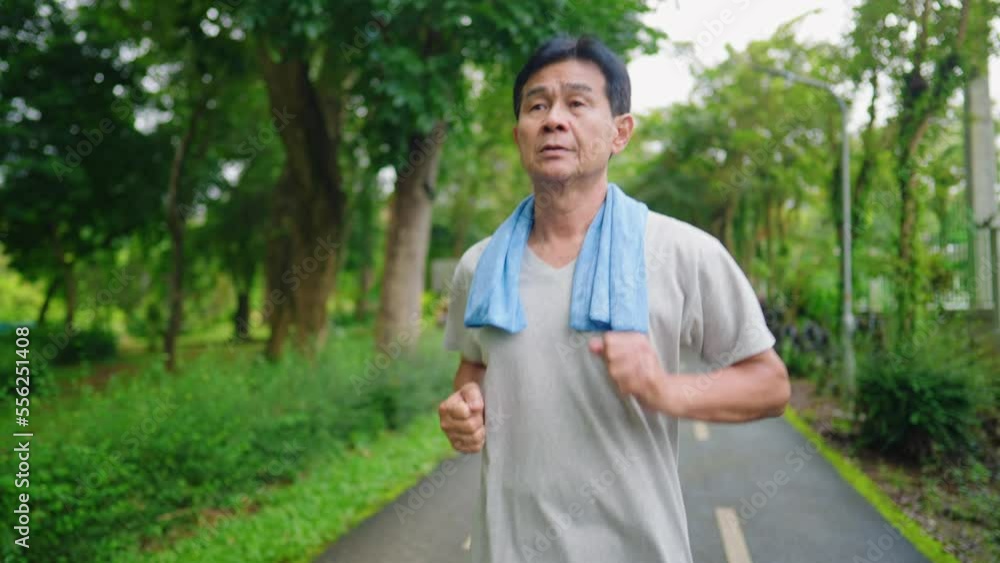 Senior asian man jogging inside the recreation park, healthy exercise ...