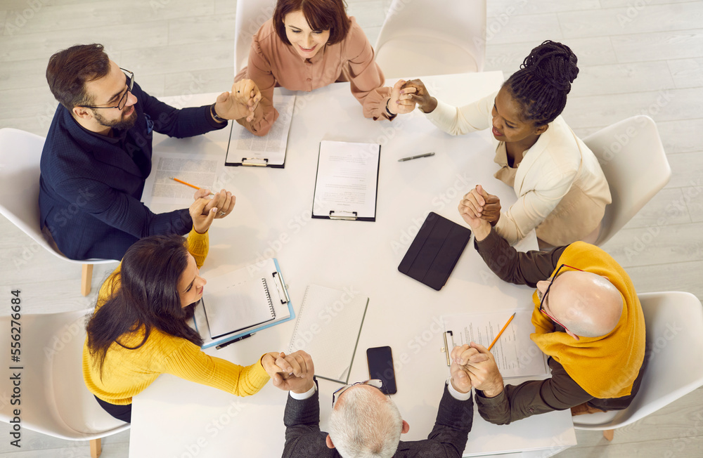 Diverse, mixed race team of different happy business people holding ...