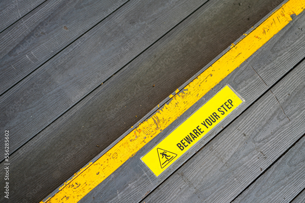 "Beware you step" caution icon symbol with yellow line at the edge of ...