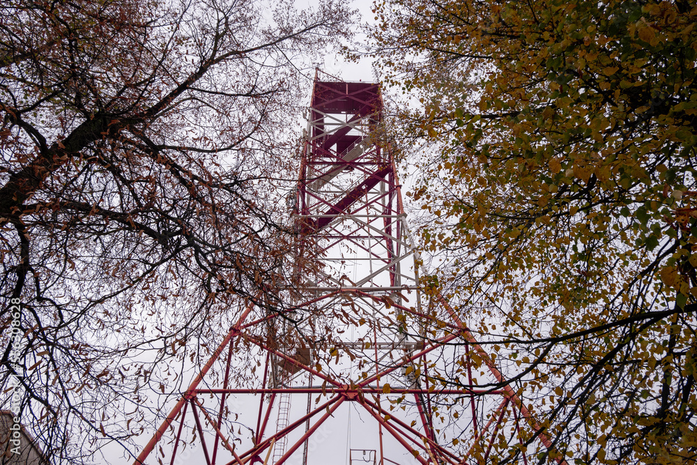 An old television and radio tower in faded colors looks vertically at ...