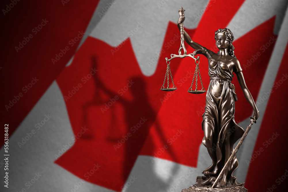 Canada flag with statue of lady justice and judicial scales in dark ...