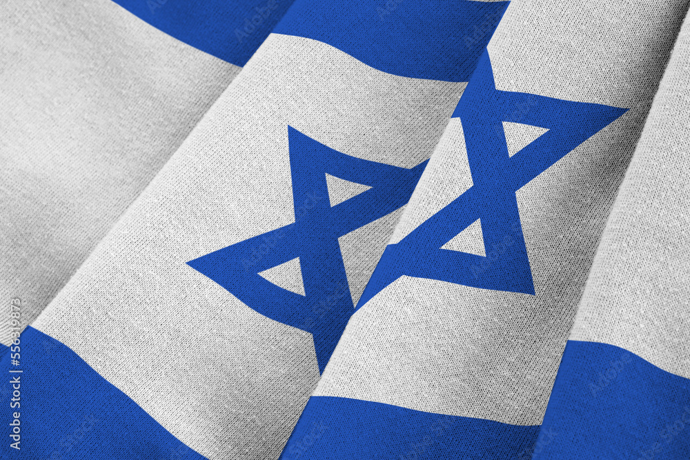 Israel flag with big folds waving close up under the studio light ...