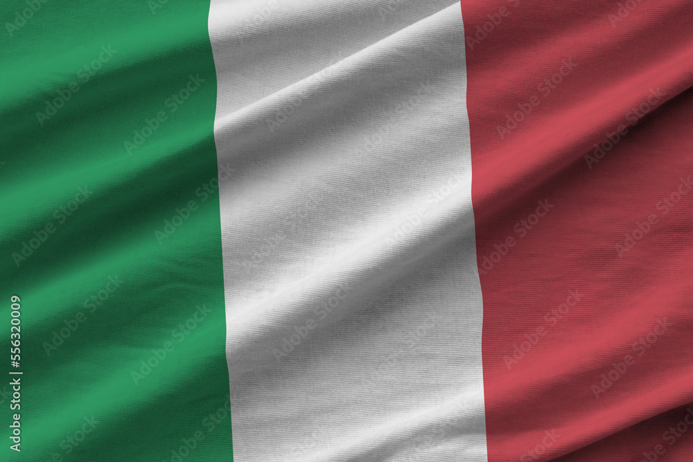 Italy flag with big folds waving close up under the studio light ...