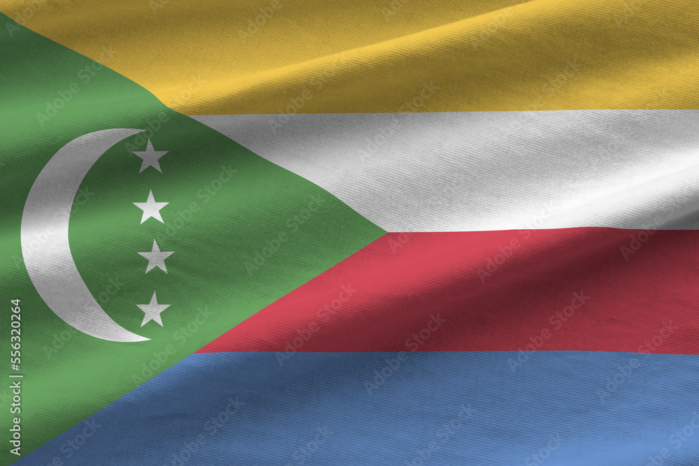 Comoros flag with big folds waving close up under the studio light ...