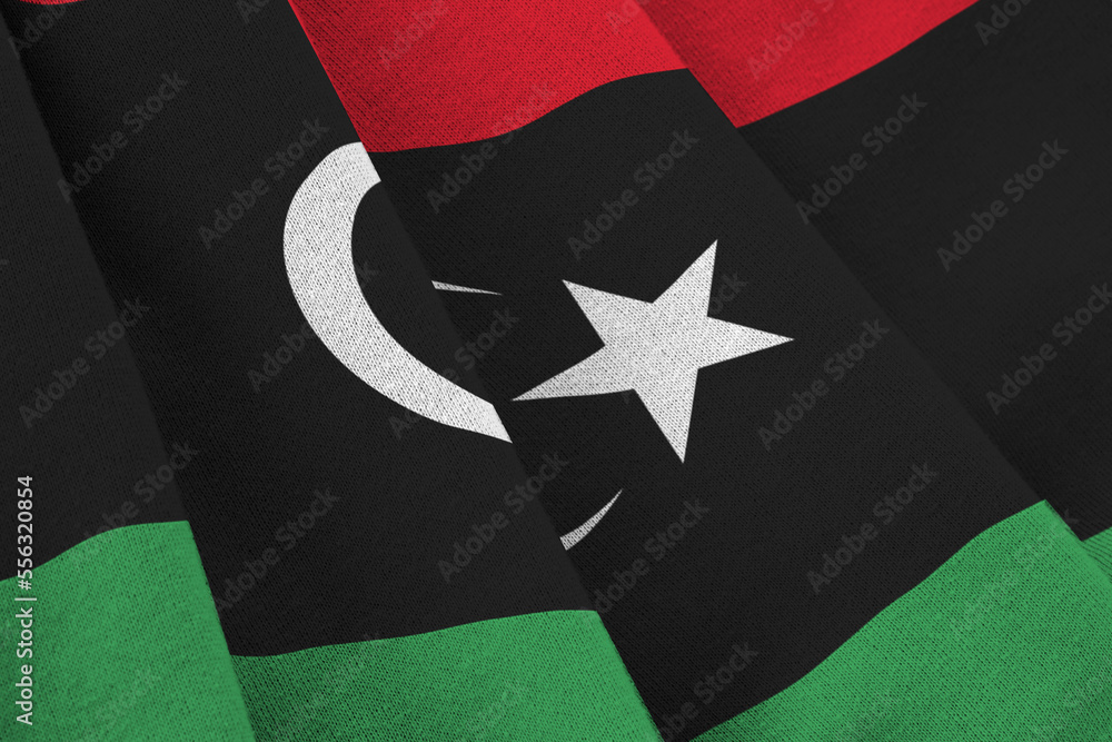 Libya flag with big folds waving close up under the studio light ...