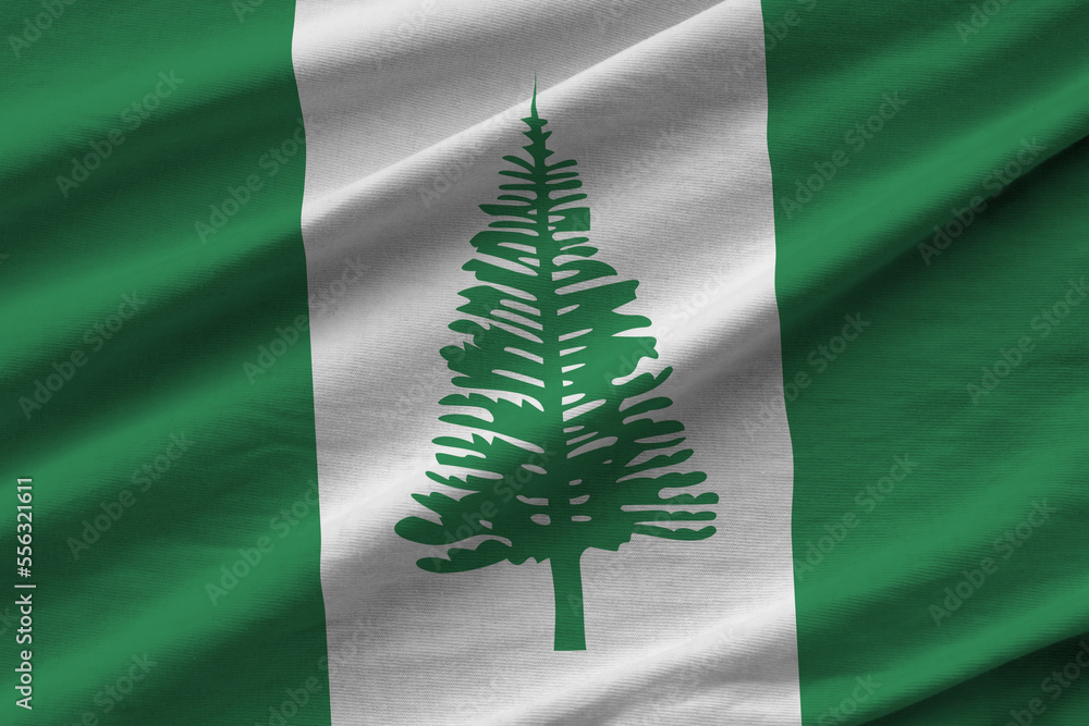 Norfolk island flag with big folds waving close up under the studio ...