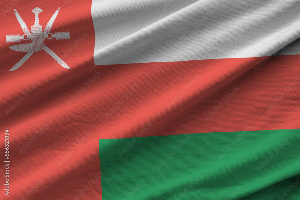 Oman flag with big folds waving close up under the studio light indoors ...