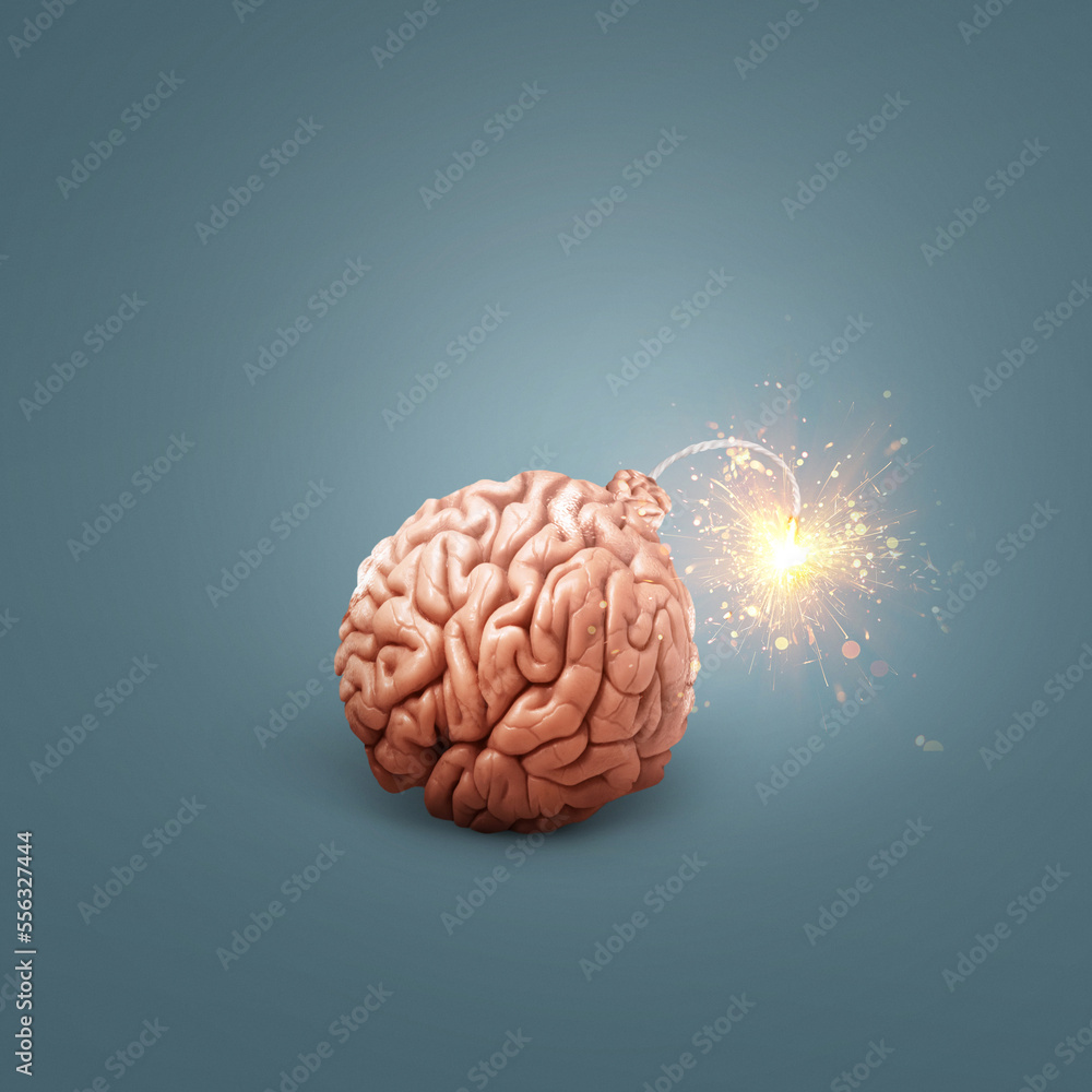 Creative brain bomb with a wick and sparks is lit on a dark blue ...
