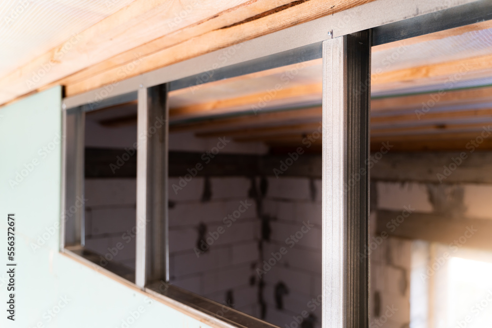 Stiffening ribs in a metal profile frame in a plasterboard wall close ...