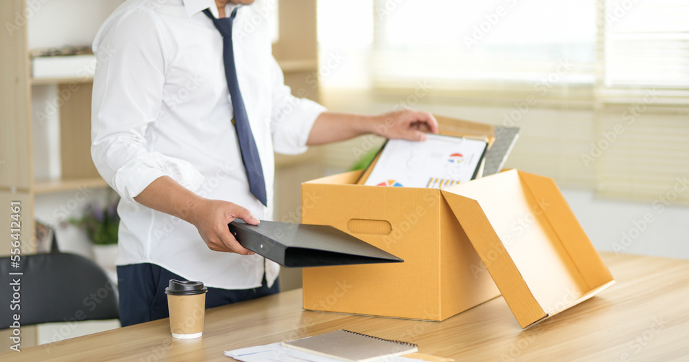 Resignation letter and cardboard box on the table, termination and ...