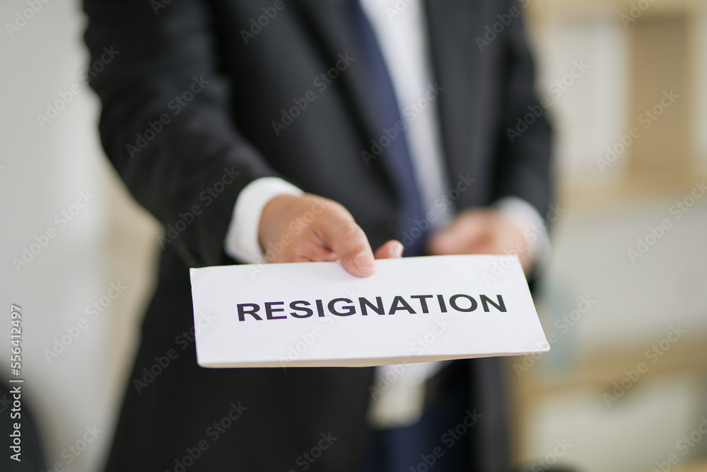 Resignation letter and cardboard box on the table, termination and ...
