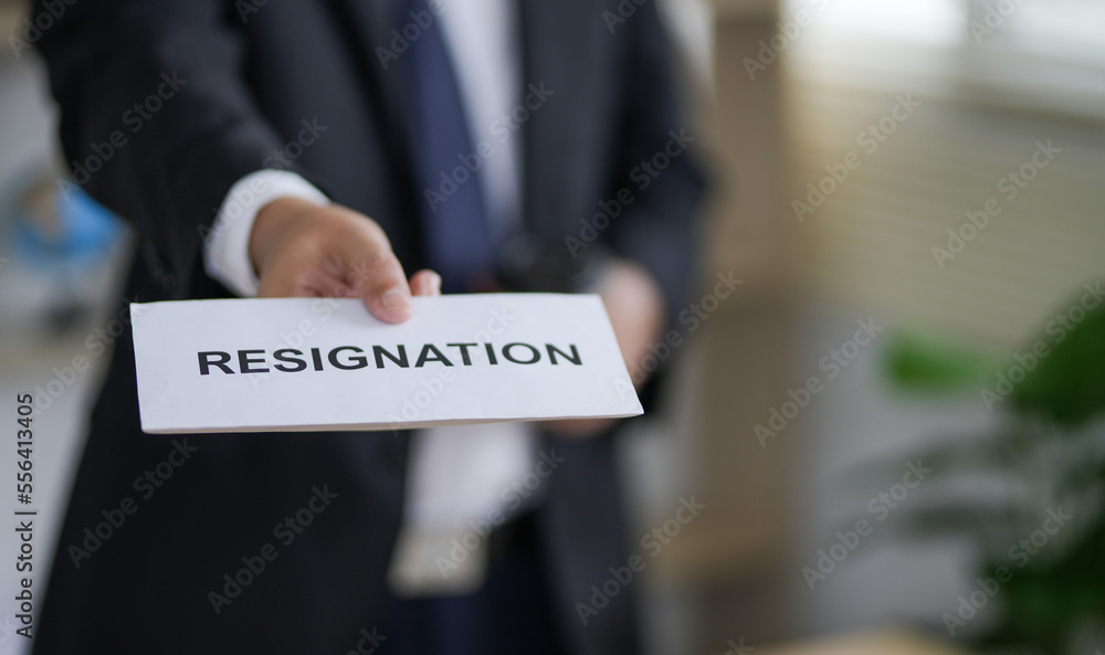 Resignation letter and cardboard box on the table, termination and ...