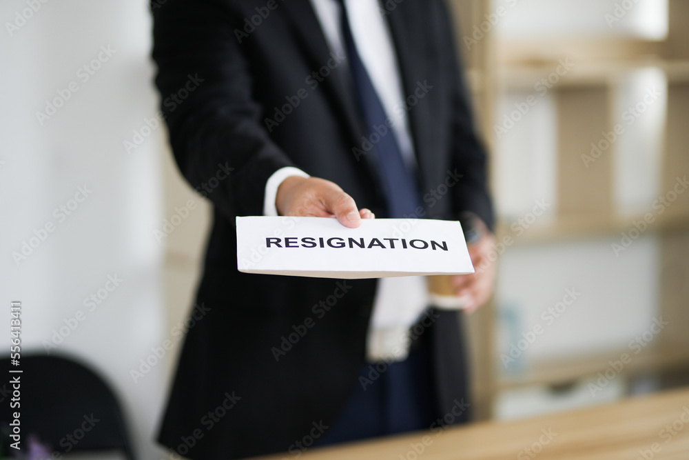 Resignation letter and cardboard box on the table, termination and ...