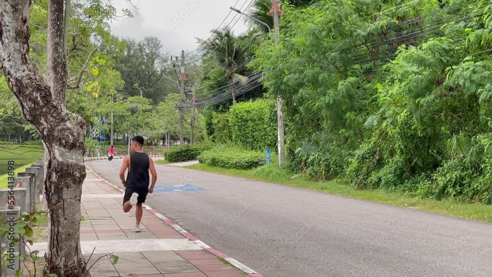 Young filipino sports man running on sidewalk. South East Asian male ...