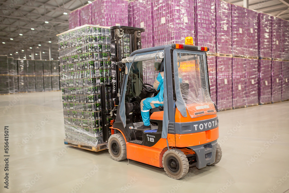 Loader loading packaged products at the factory. Conveyor line for the ...