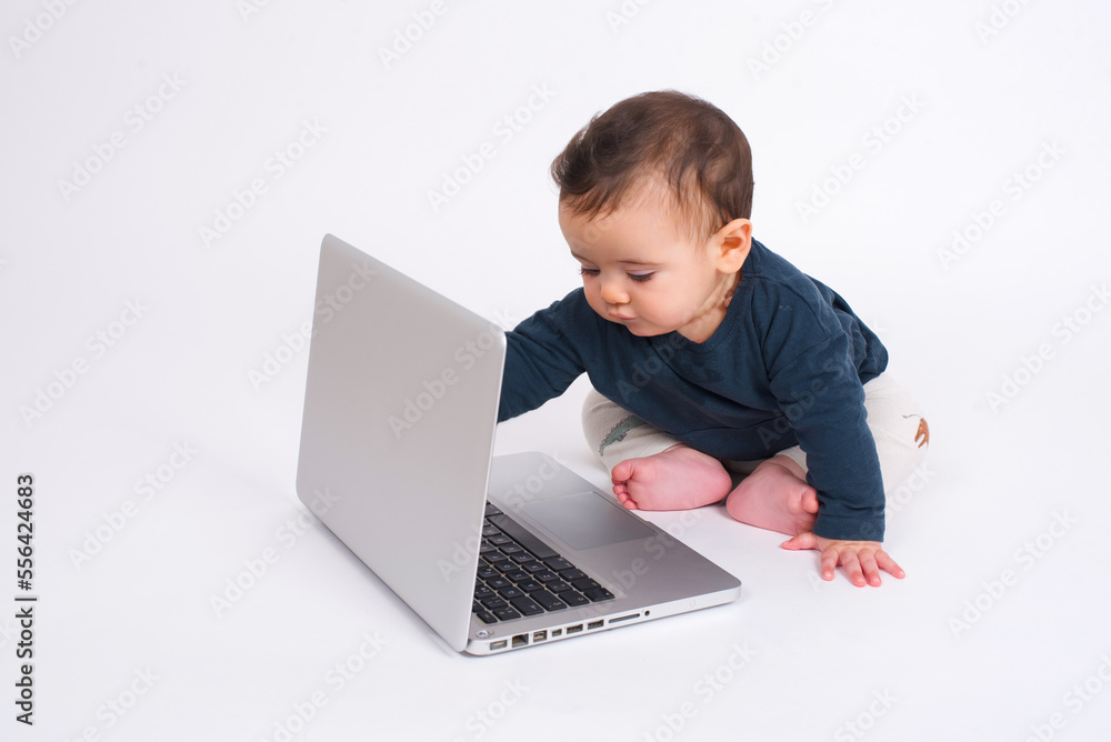 Cute adorable baby boy sitting on white studio background sitting on ...