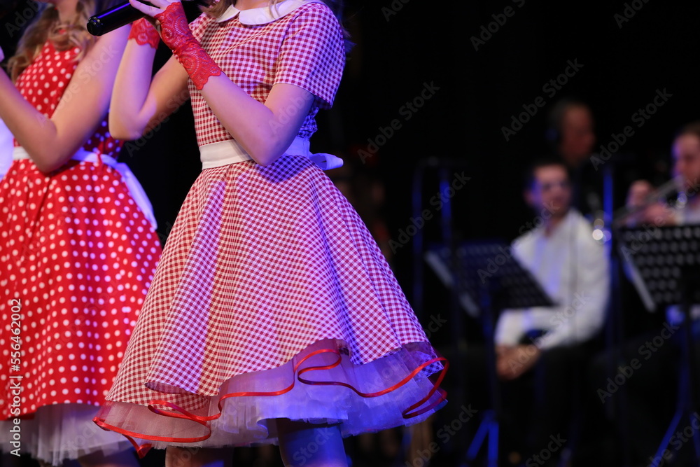 Singer in a red dress on stage in action Stock Photo | Adobe Stock
