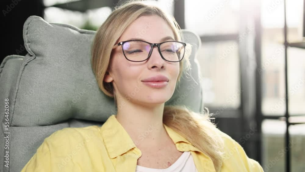 Relaxed calm businesswoman with closing eyes laying on chair after hard ...