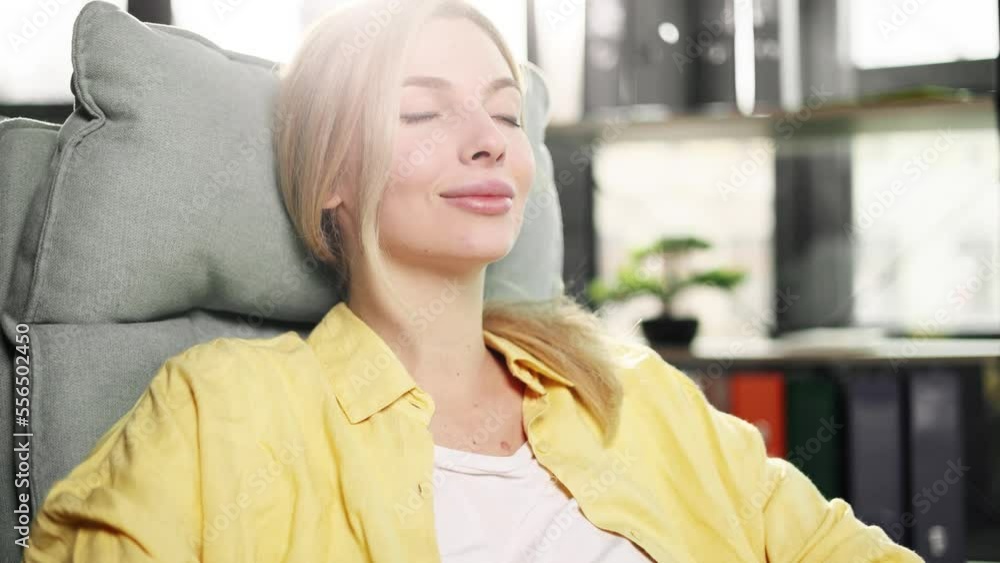 Relaxed calm businesswoman with closing eyes laying on chair after hard ...