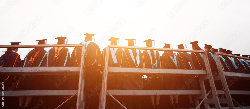 back view The group of graduates celebrated their college graduation ...