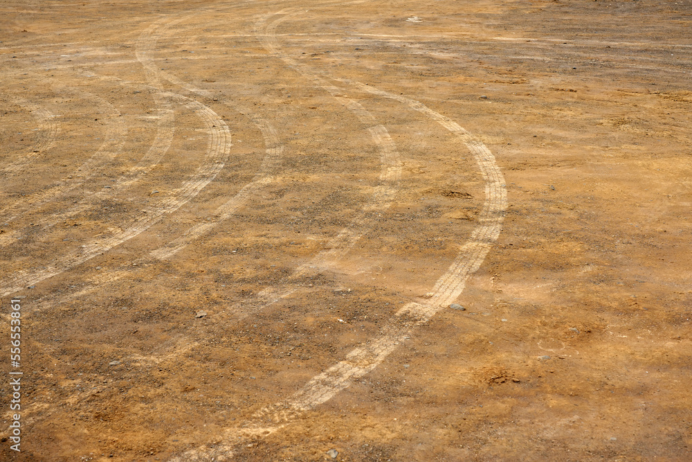 Tire tread marks on the ground as a backdrop. Stock Photo | Adobe Stock