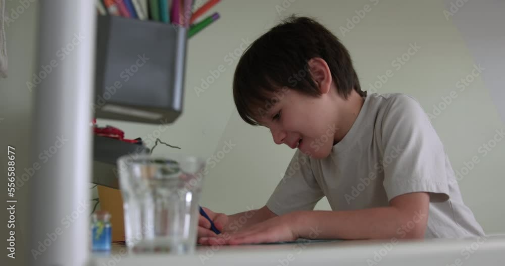Grade one boy drawing art in bedroom - side profile tracking shot Stock ...