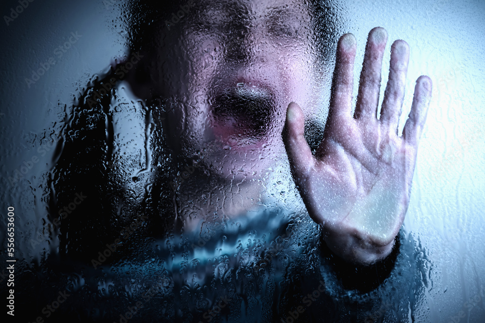 Dramatic portrait of young girl with a raised hand making a stop sign ...