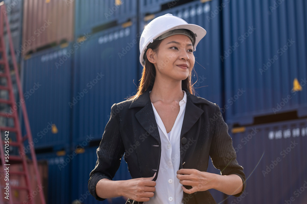 Smile Asian woman logistics worker wear safety helmet and protect suite ...