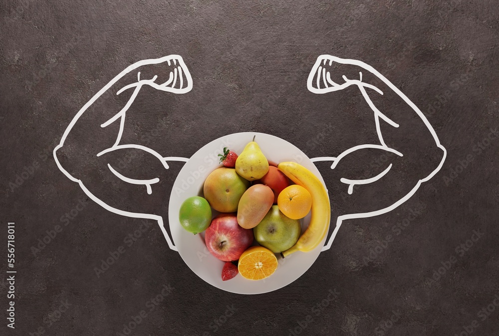 Muscles on the background of a plate with different fruits. The concept ...