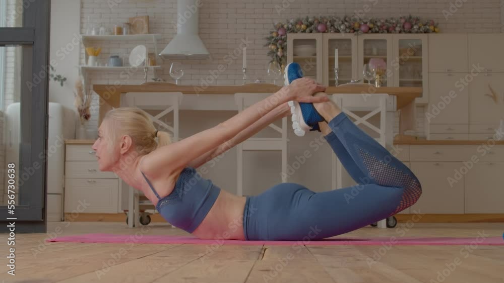 Motivated active attractive fit mature woman in sportswear practicing ...