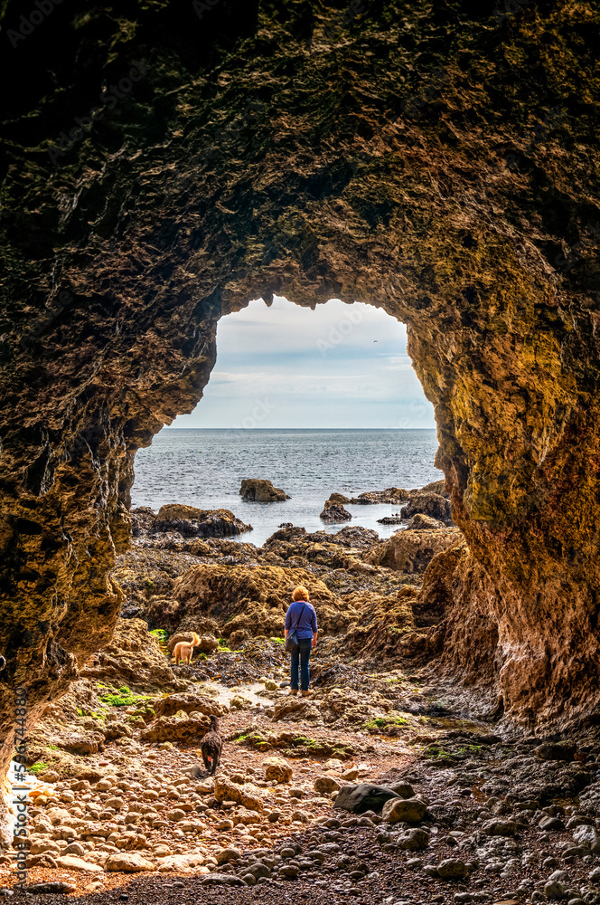 Looking through archway of a limestone cave on Marsden Beach to a view ...