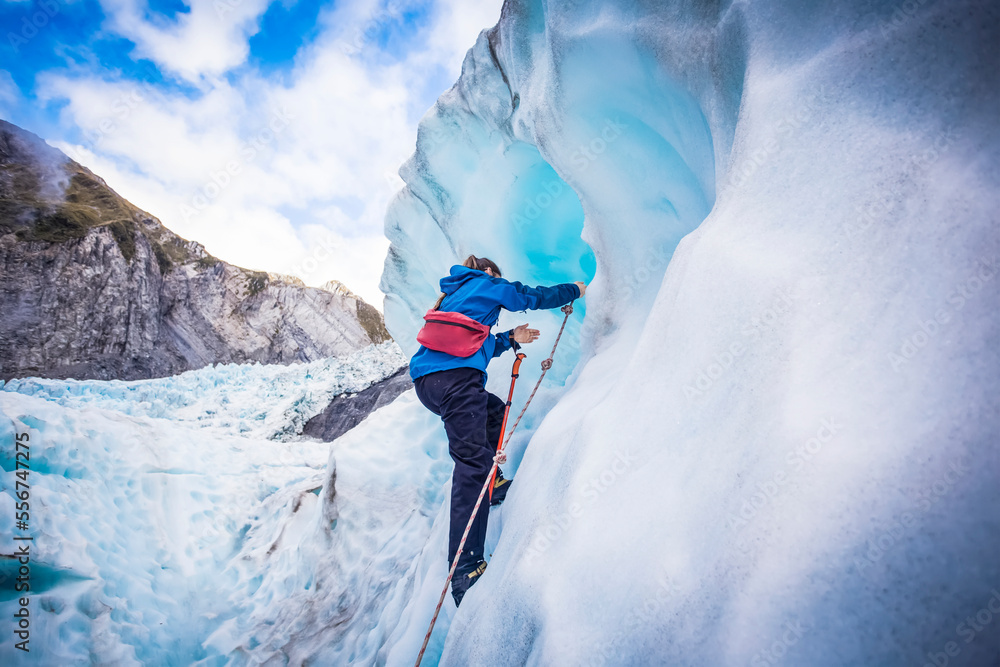 Travellers explore New Zealand's famous Franz Josef Glacier. Blue Ice ...