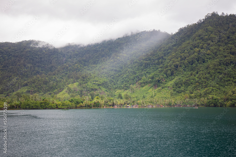 Steam rising over the jungle hills with Siboma Village along the ...