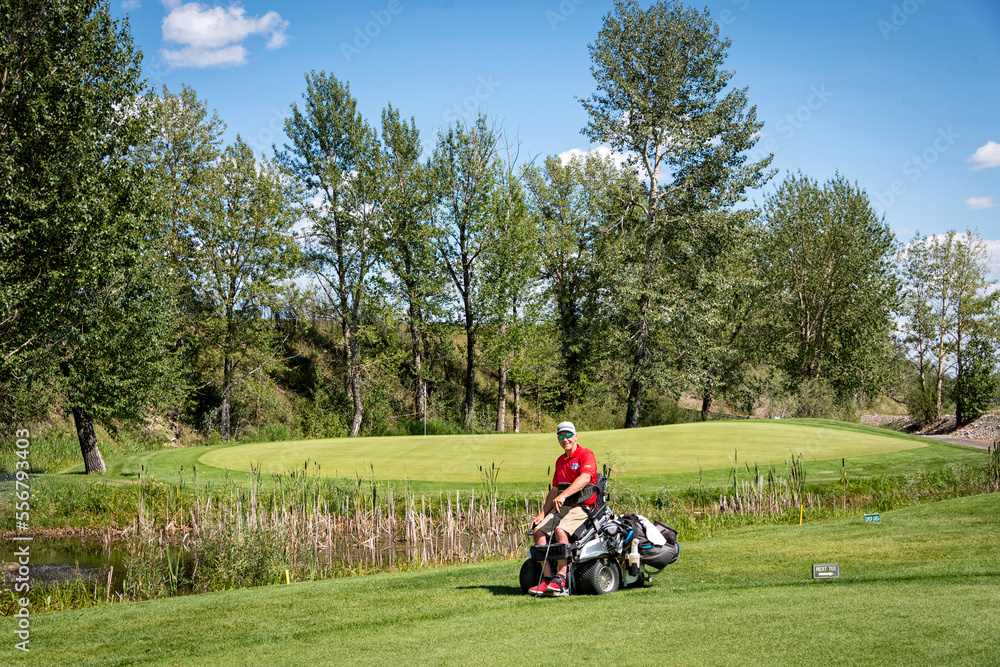 Disabled golfer using a specialized golf assistance motorized hydraulic ...