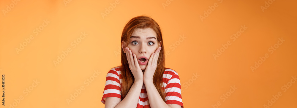 Close-up shocked speechless redhead woman, drop jaw gasping, touch ...