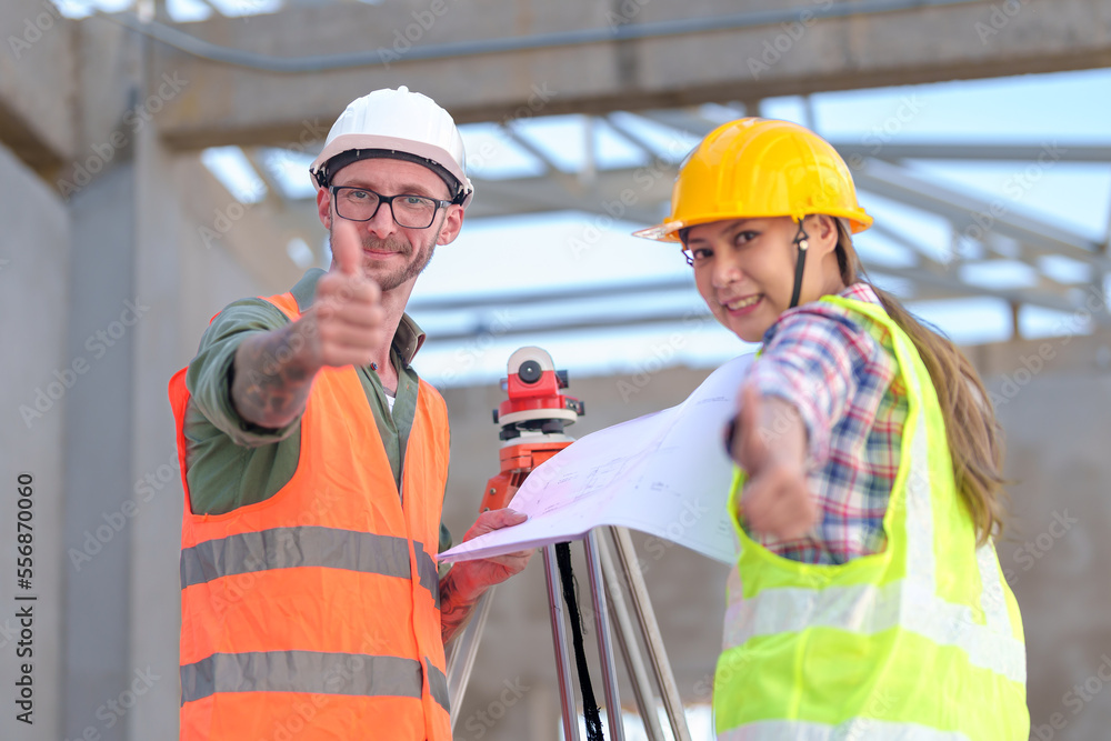 Two Construction Worker show success Using Theodolite Surveying Optical ...